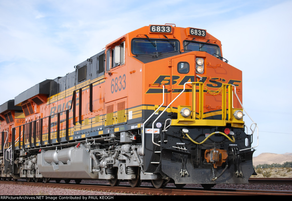 BNSF 6833 close up as she waits to head east with another Double Stack ahead of her at Daggett ...